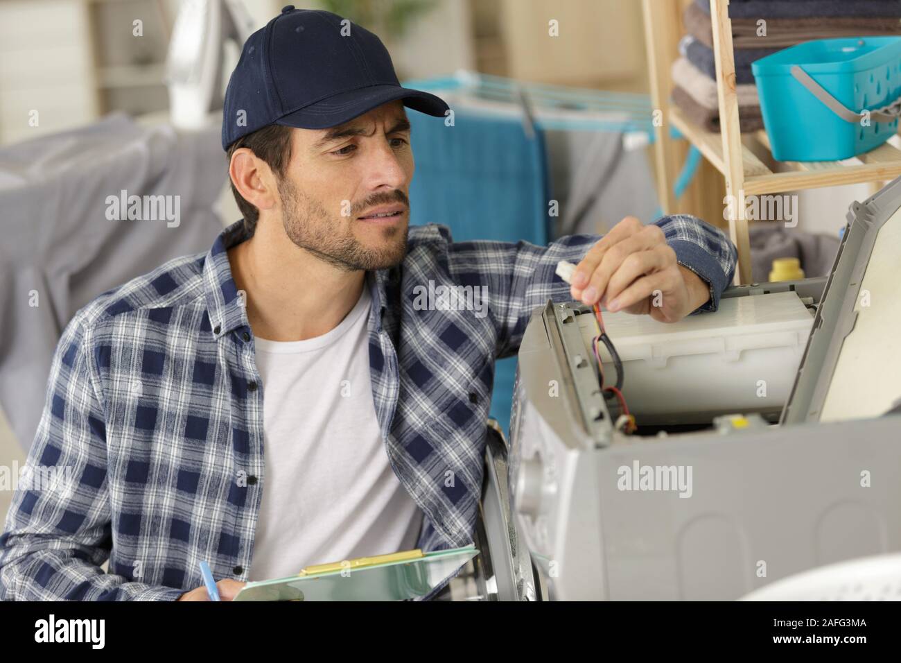 technician repairing a washing machine Stock Photo - Alamy