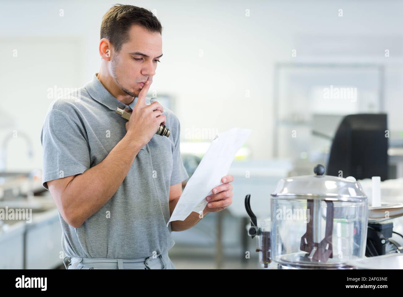man checking list on clipboard in a warehouse Stock Photo - Alamy