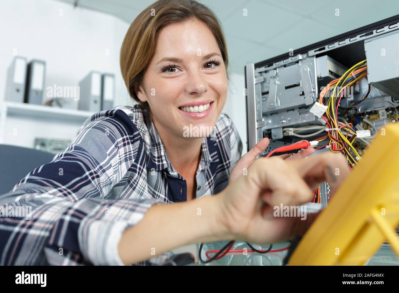 happy female technician fixing a pc Stock Photo - Alamy