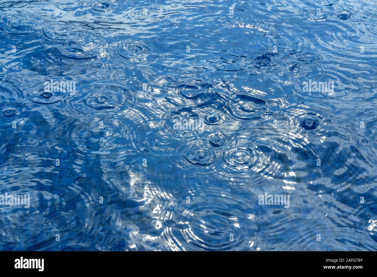 Blue water surface texture during rain. Monochrome classic blue ...