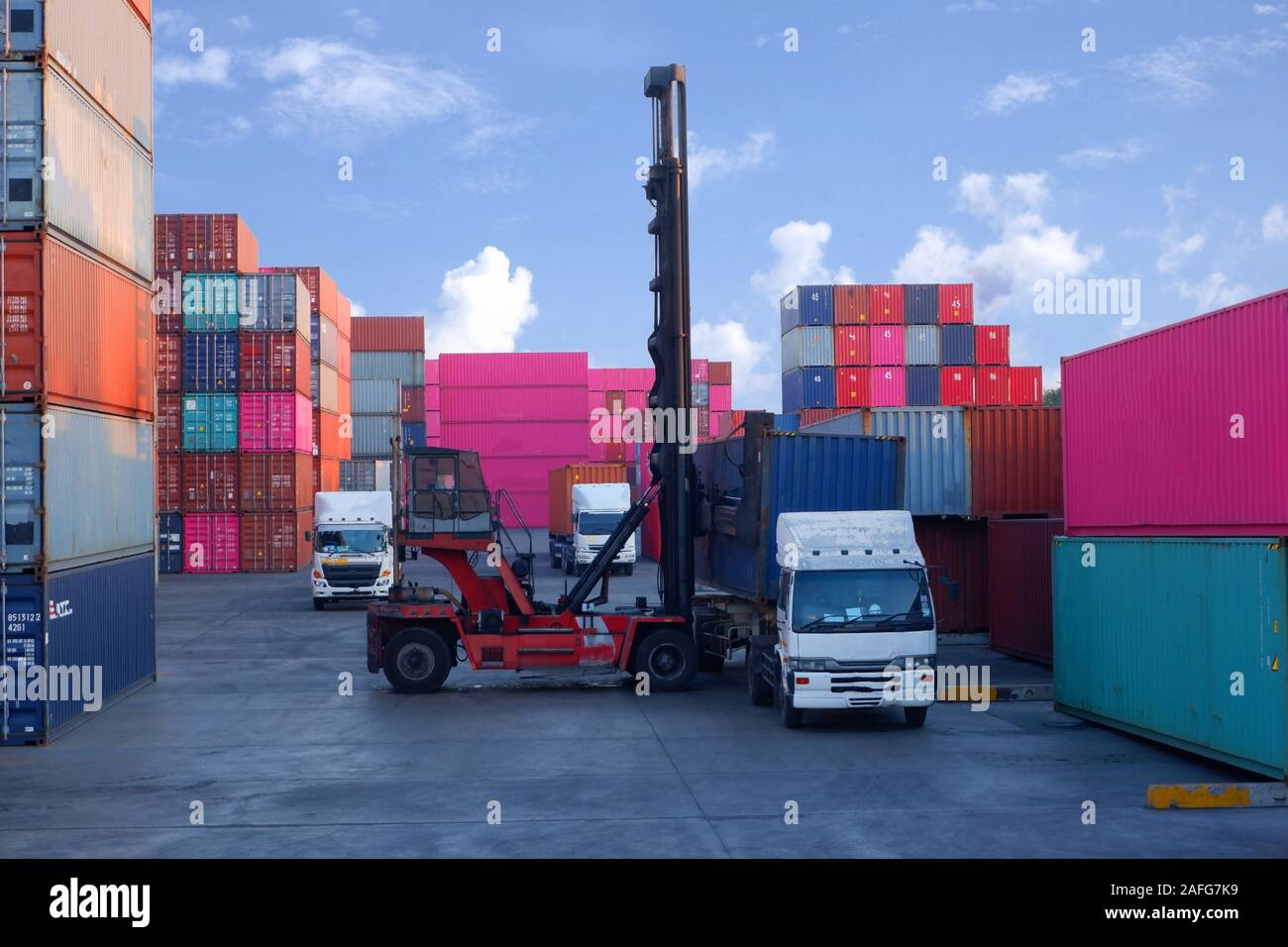 Container handlers Load the container into the truck Stock Photo - Alamy