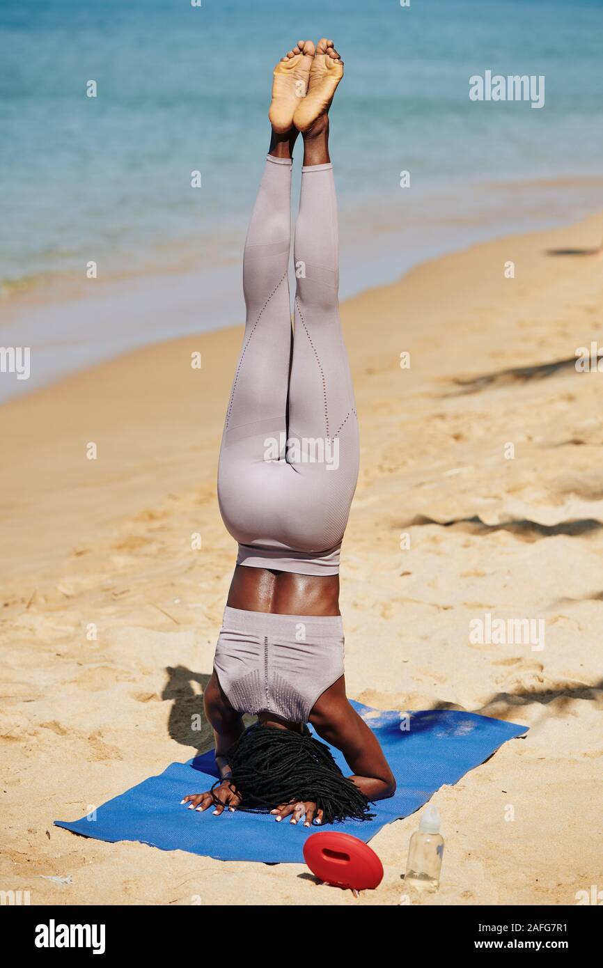 Woman headstand beach hi-res stock photography and images - Alamy