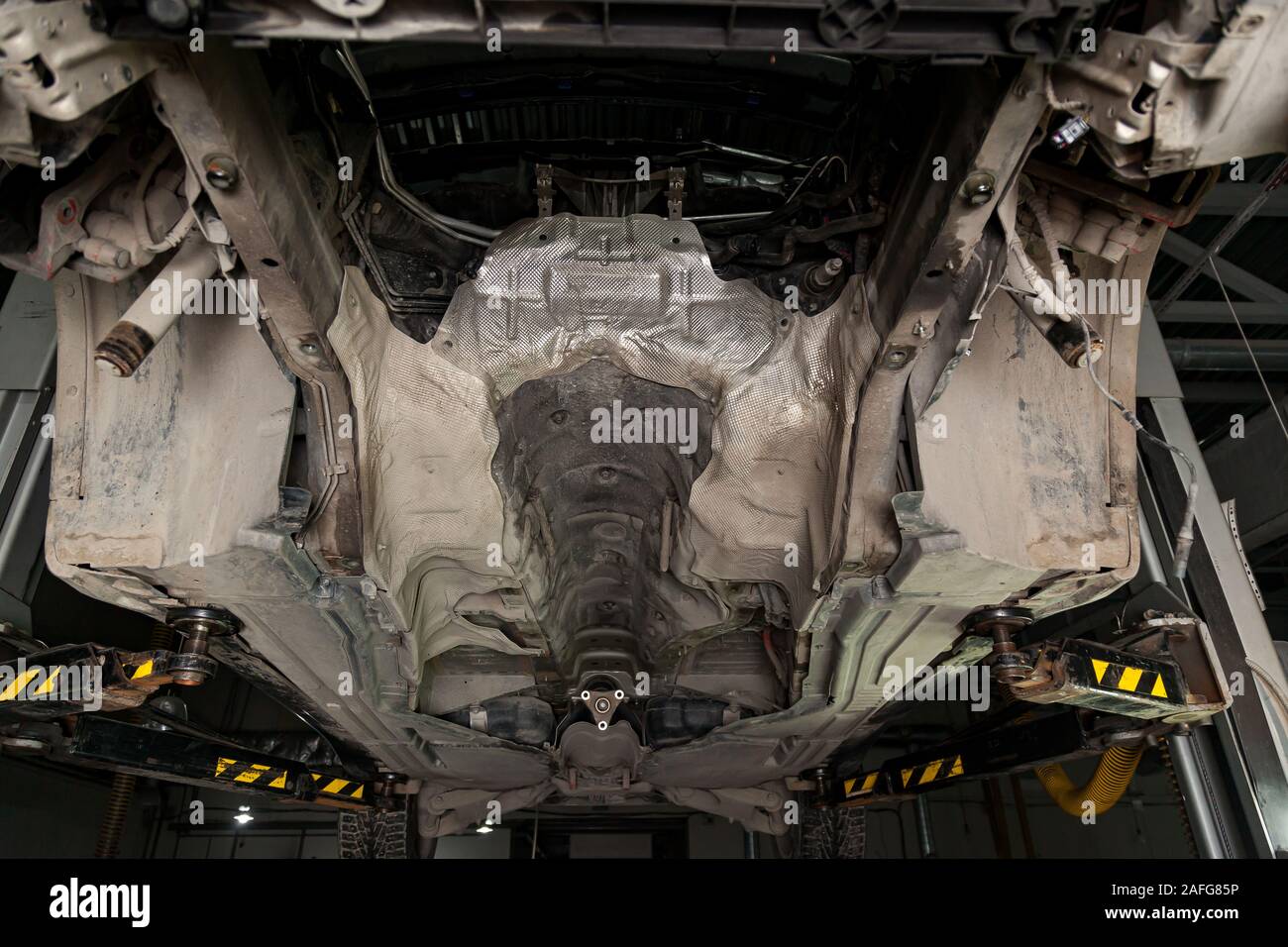 The bottom of the car lifted on a hydraulic lift during overhaul with ...