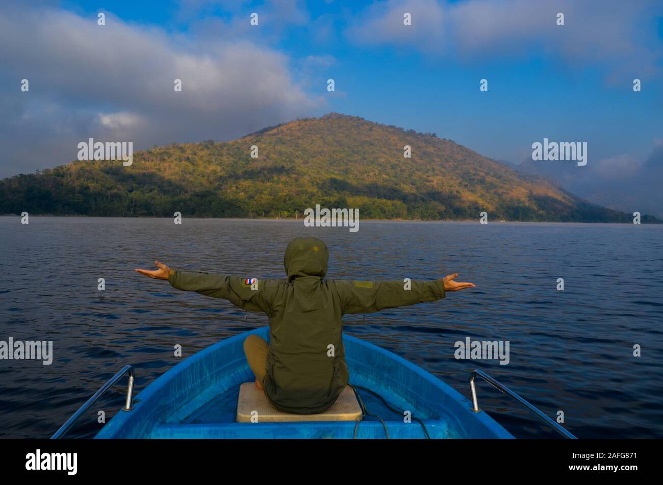 freedom men siting on boad on river with hand up Stock Photo - Alamy