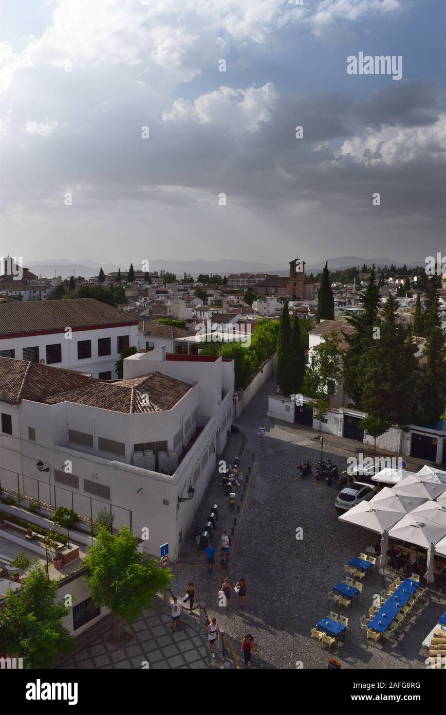 Rays of intense sunlight penetrate through dark clouds above Granada ...