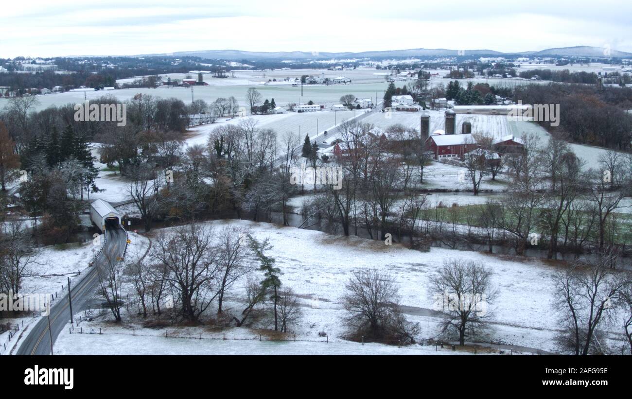 American countryside after first snow in season, covered bridge hidden ...