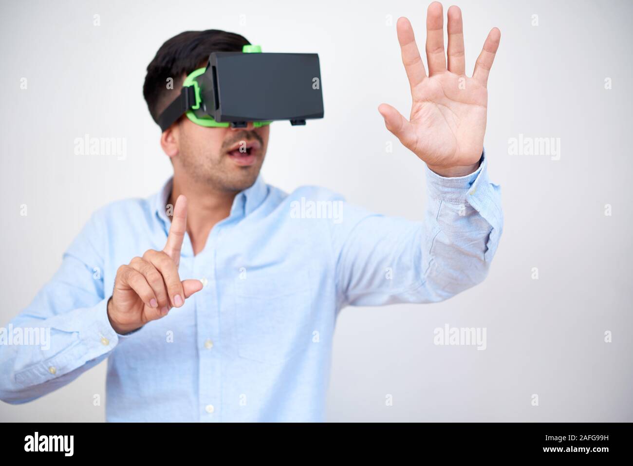 Excited businessman doing hand gestures when working in virtual reality ...