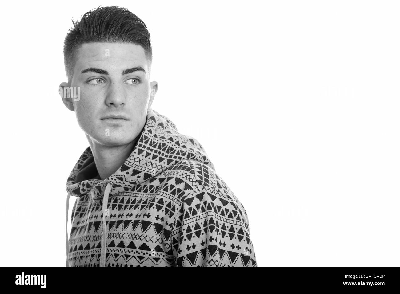 Studio shot of young handsome man looking back Stock Photo - Alamy