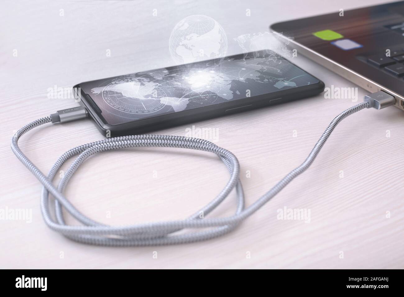 The photo of the mobile phone connect to the laptop. Isolated on a ...