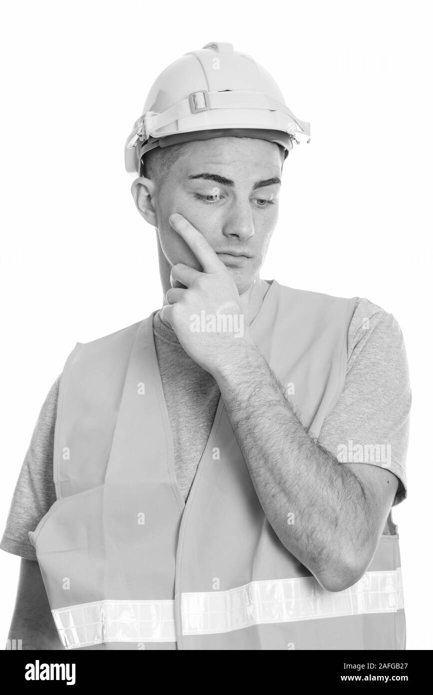 Studio shot of young handsome man construction worker thinking Stock ...