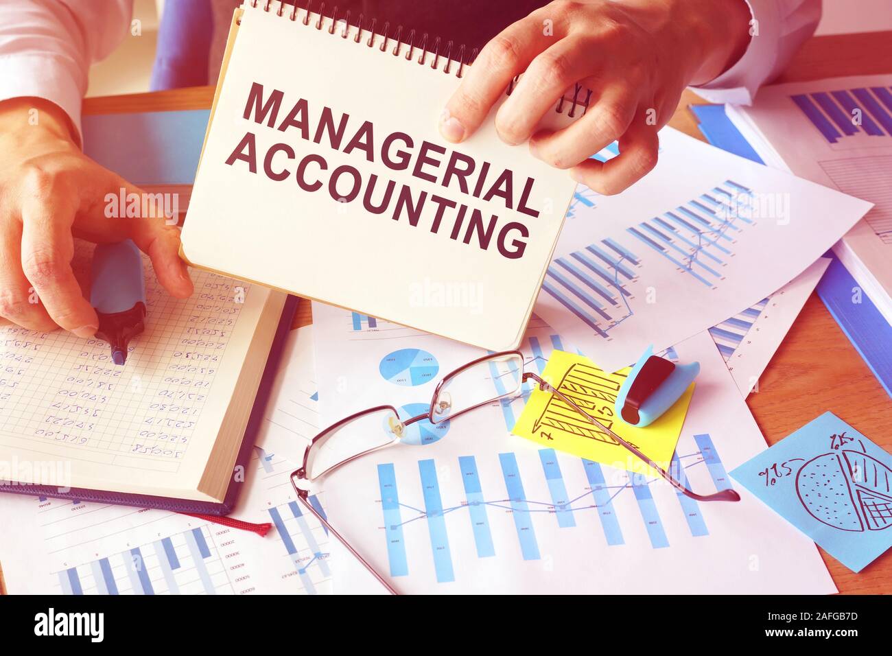 Managerial accounting concept. Stack of business documents in the ...
