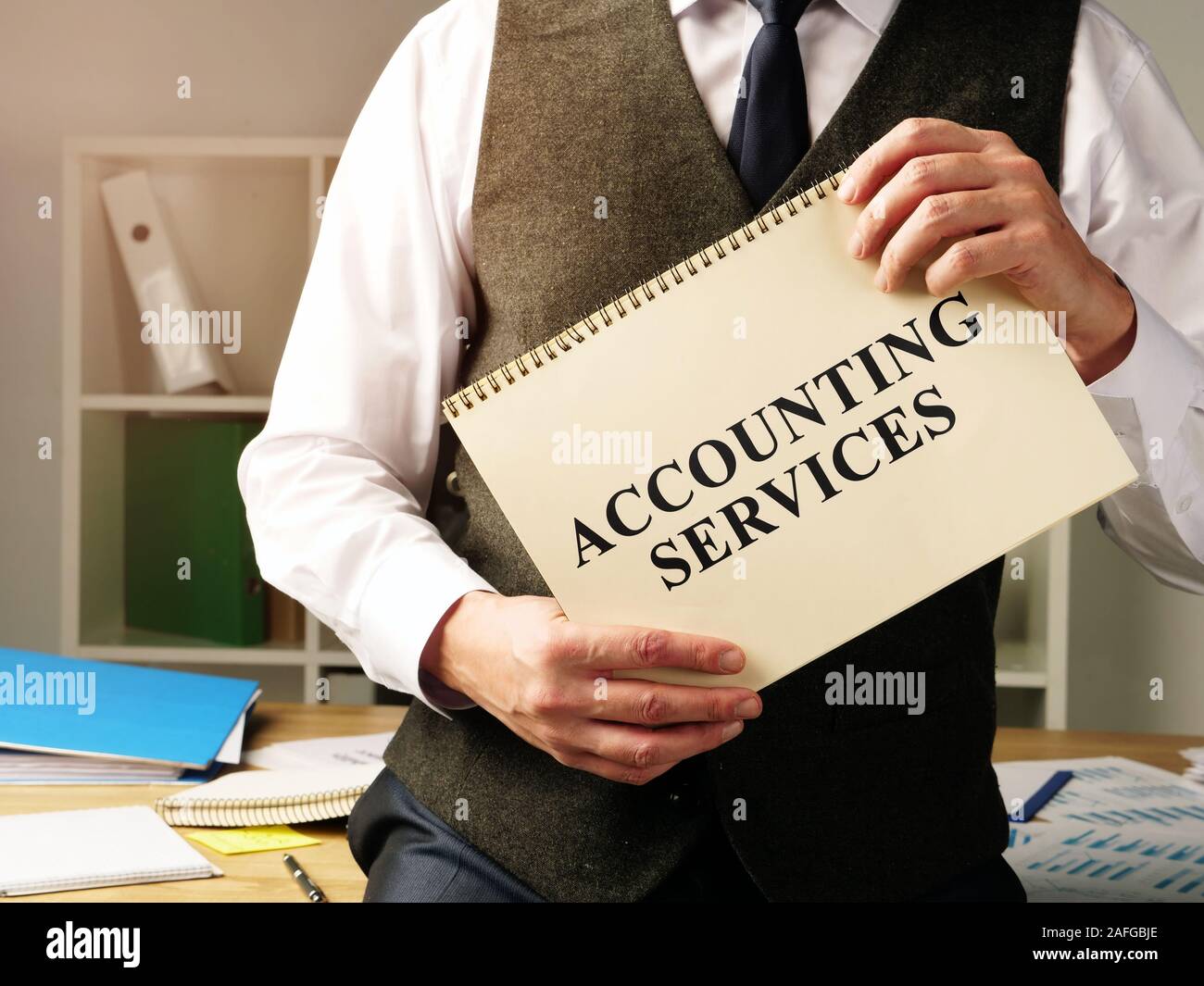 Accounting services sign in the hands of accountant Stock Photo - Alamy