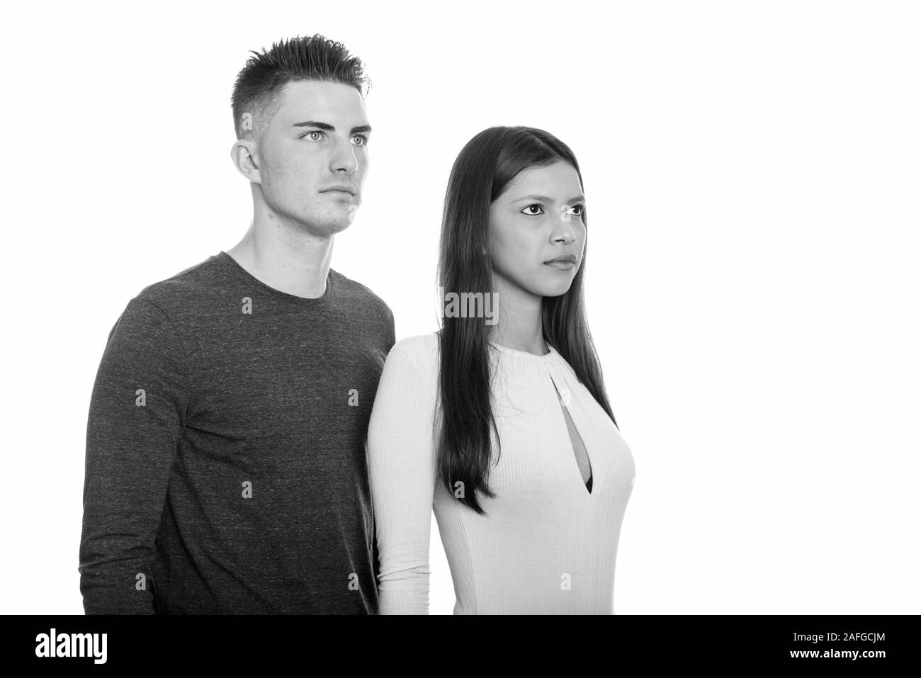 Studio shot of young couple looking at the distance together Stock ...
