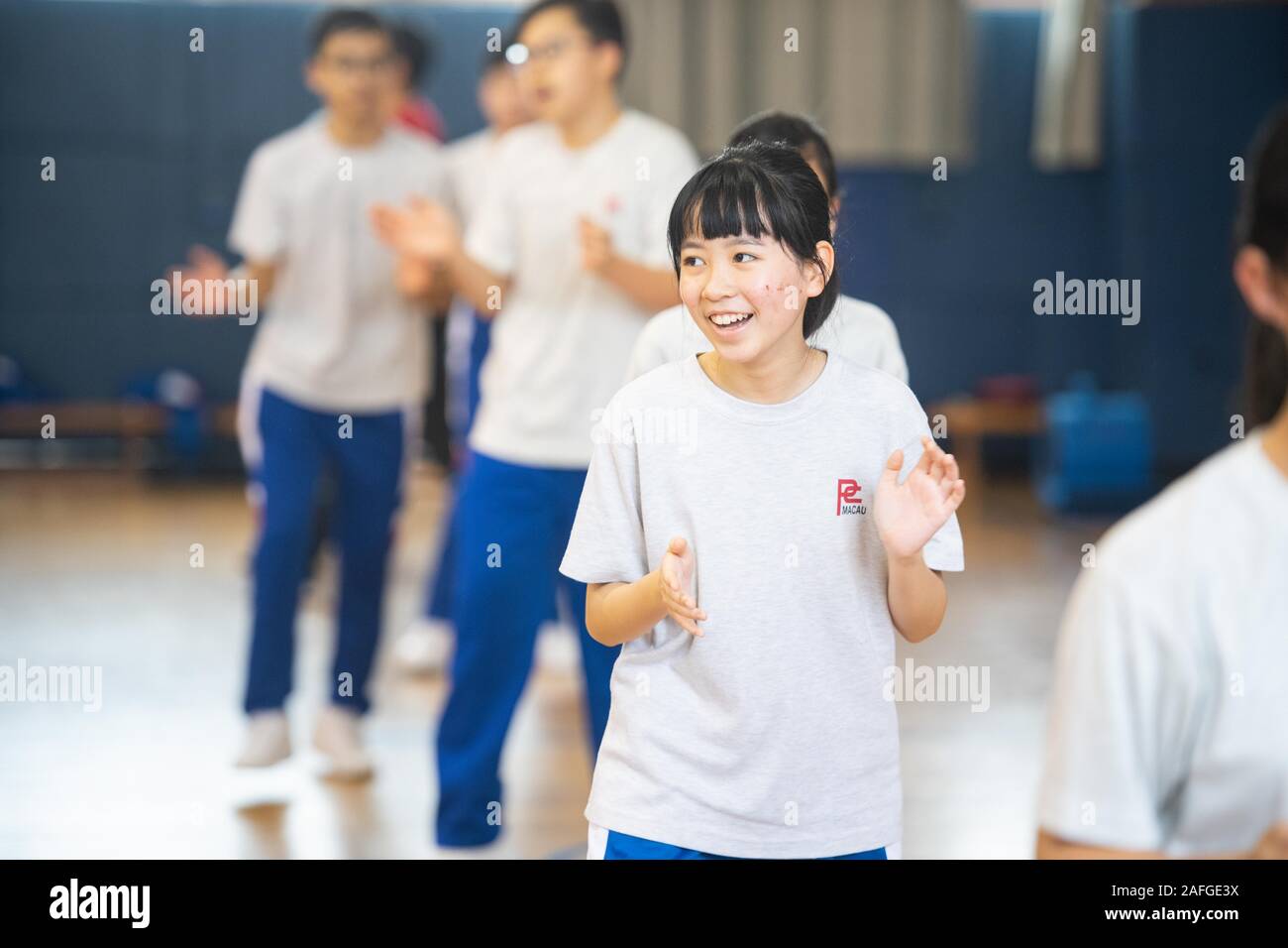 Macao, China. 21st Mar, 2019. Students have PE class at the Pui Ching Middle School in Macao ...
