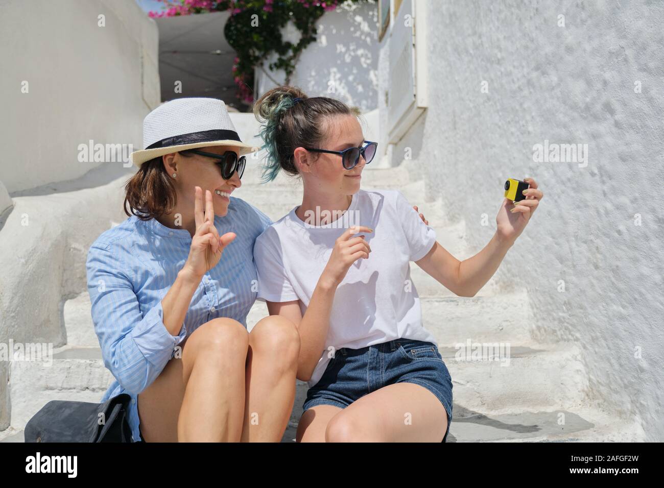 Two women mother and daughter teenager traveling together and recording ... Two women mother and daughter teenager traveling together and recording ...