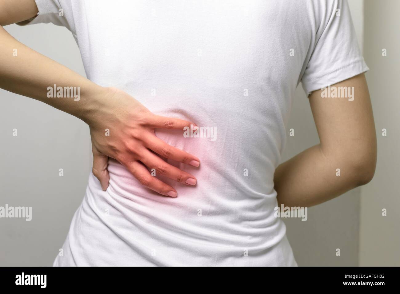 Concept of woman stretching suffering from sudden back pain. Woman ...