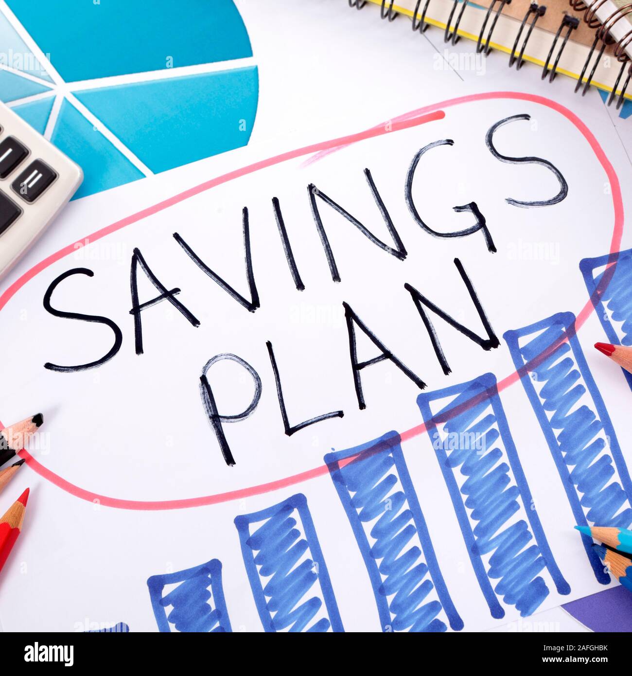 The words Savings Plan written on a hand drawn bar chart surrounded by ...