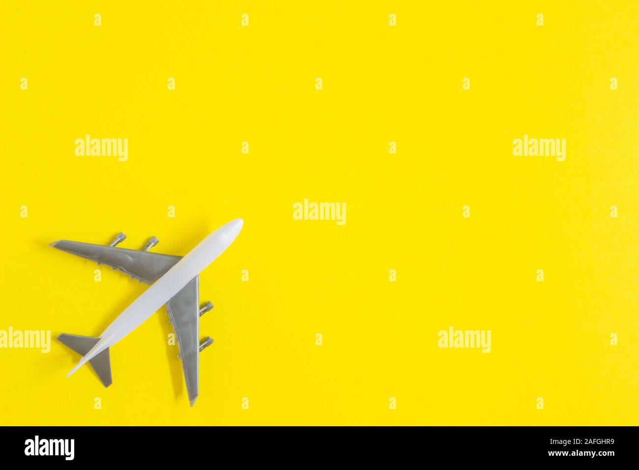 Modern passenger plane on yellow paper backdrop. Concept of aircraft ...