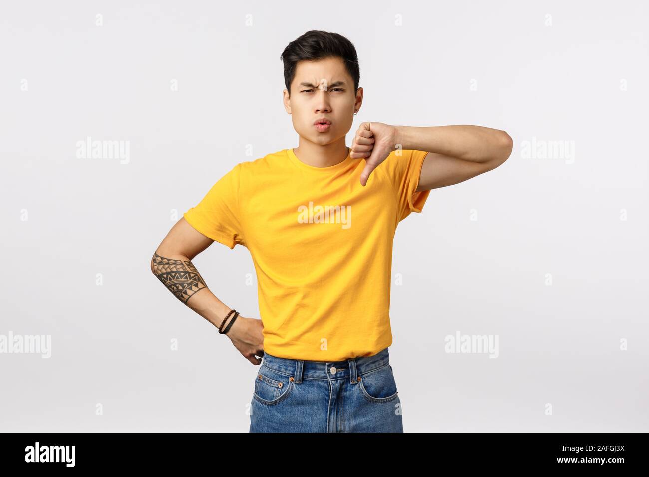 You look like loser. Displeased and disappointed young handsome asian ...