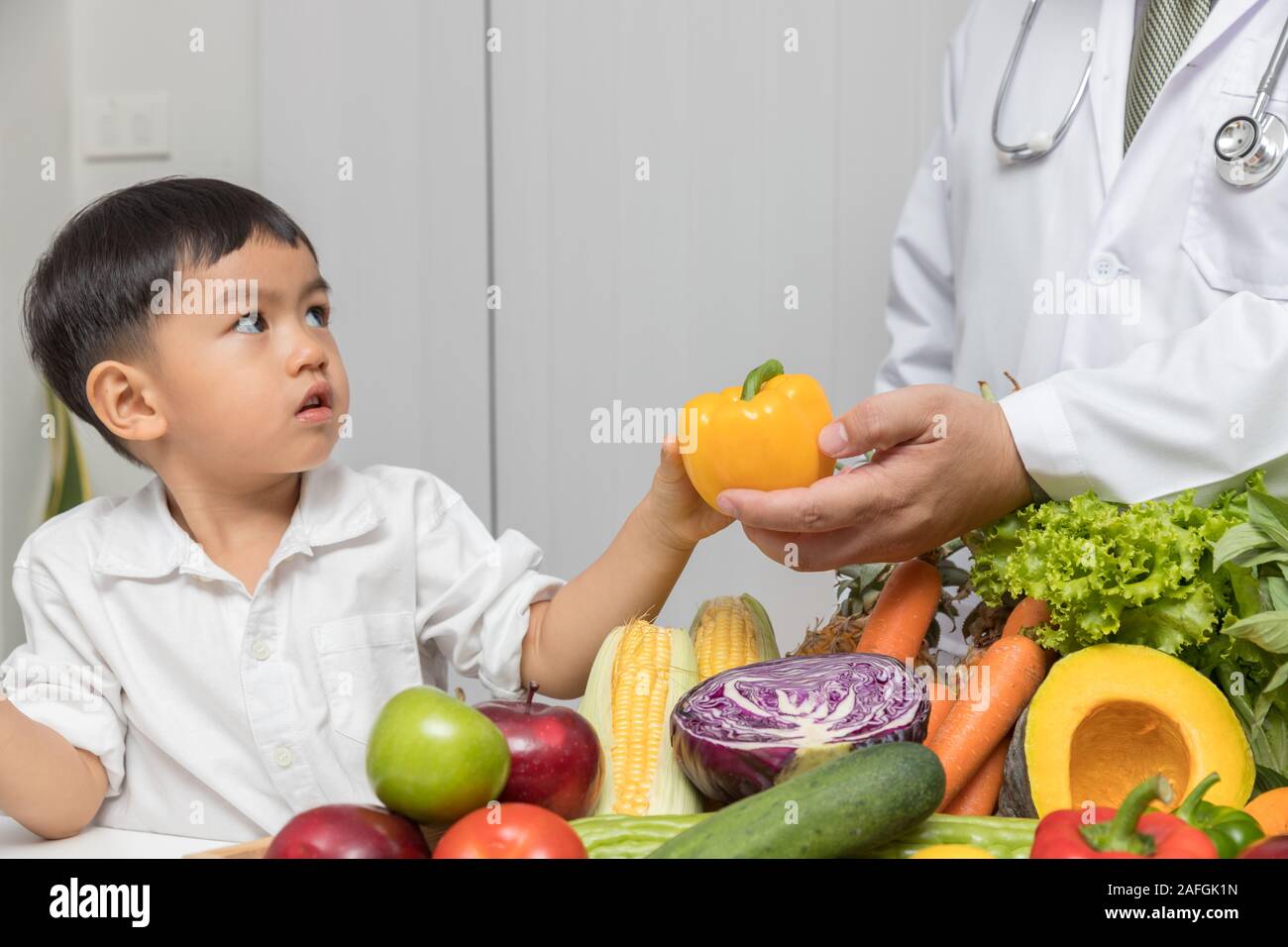Healthy and nutrition concept. Kid learning about nutrition with doctor ...