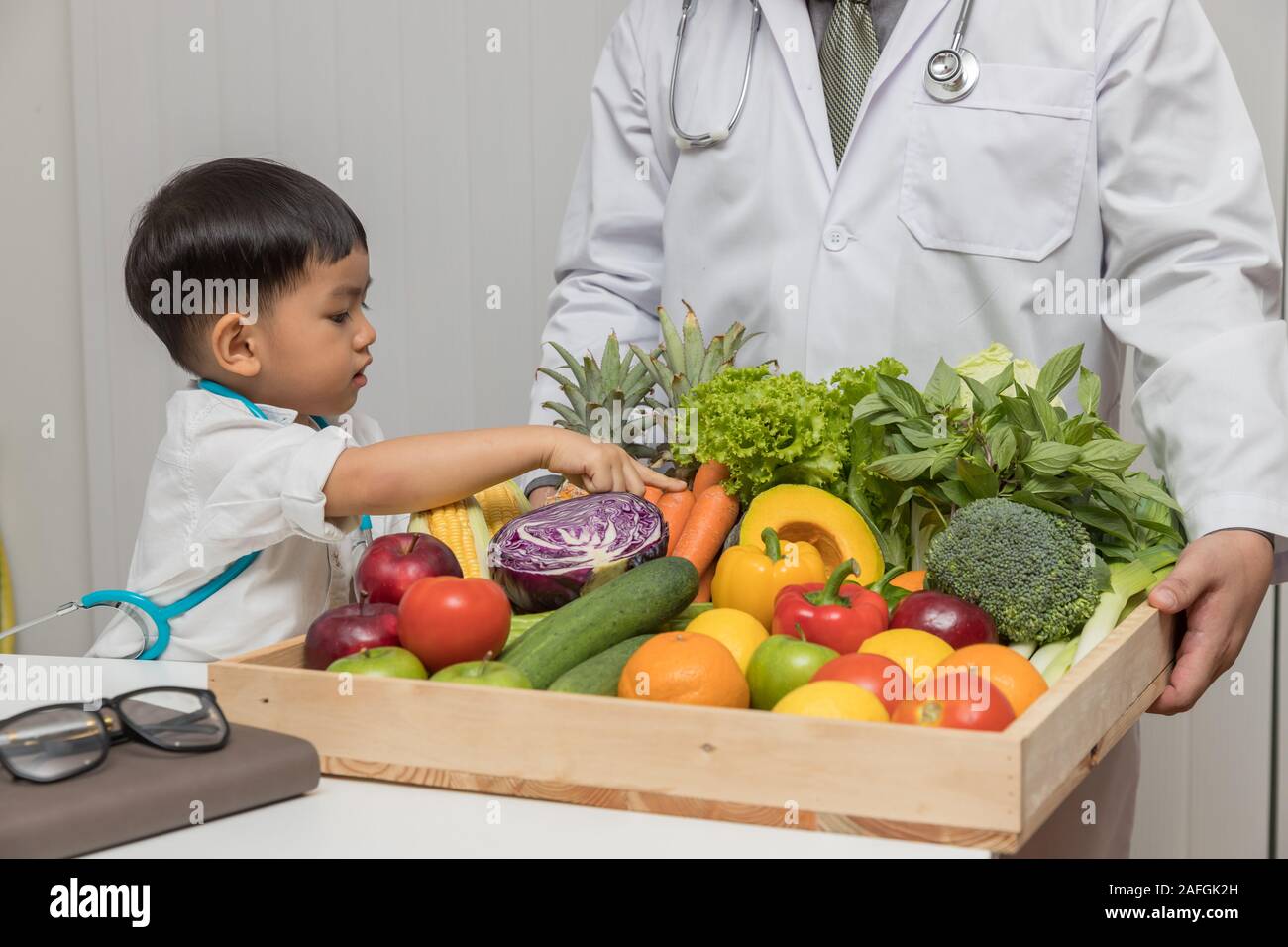 Healthy and nutrition concept. Kid learning about nutrition with doctor ...