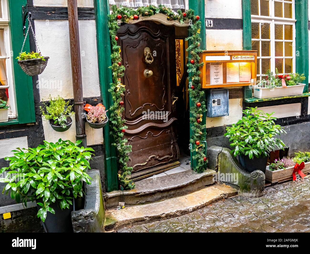 Entrance to a traditional German pub decorated with festive trimmings ...