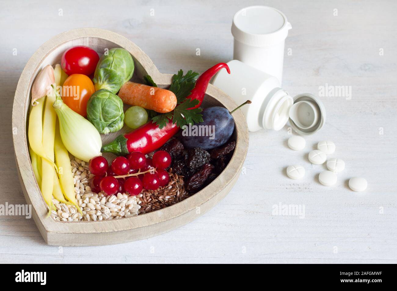 Healthy food in heart and medicaments diet concept Stock Photo - Alamy