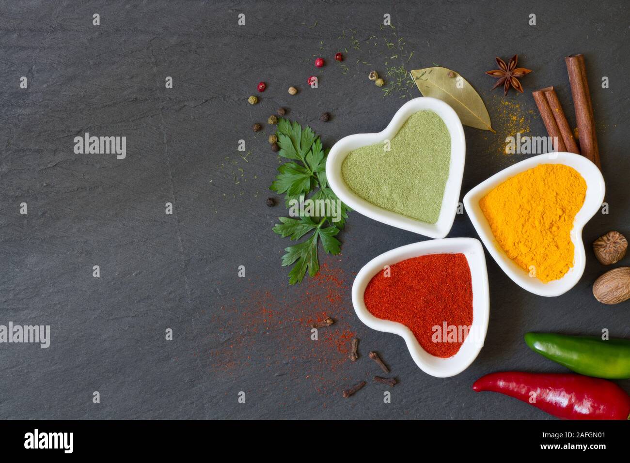 Spices in little white bowls - hearts on wooden boards concept Stock ...