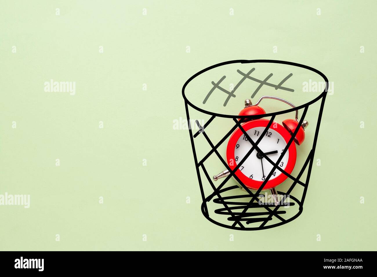 Red alarm clock in a waste paper bin Stock Photo - Alamy