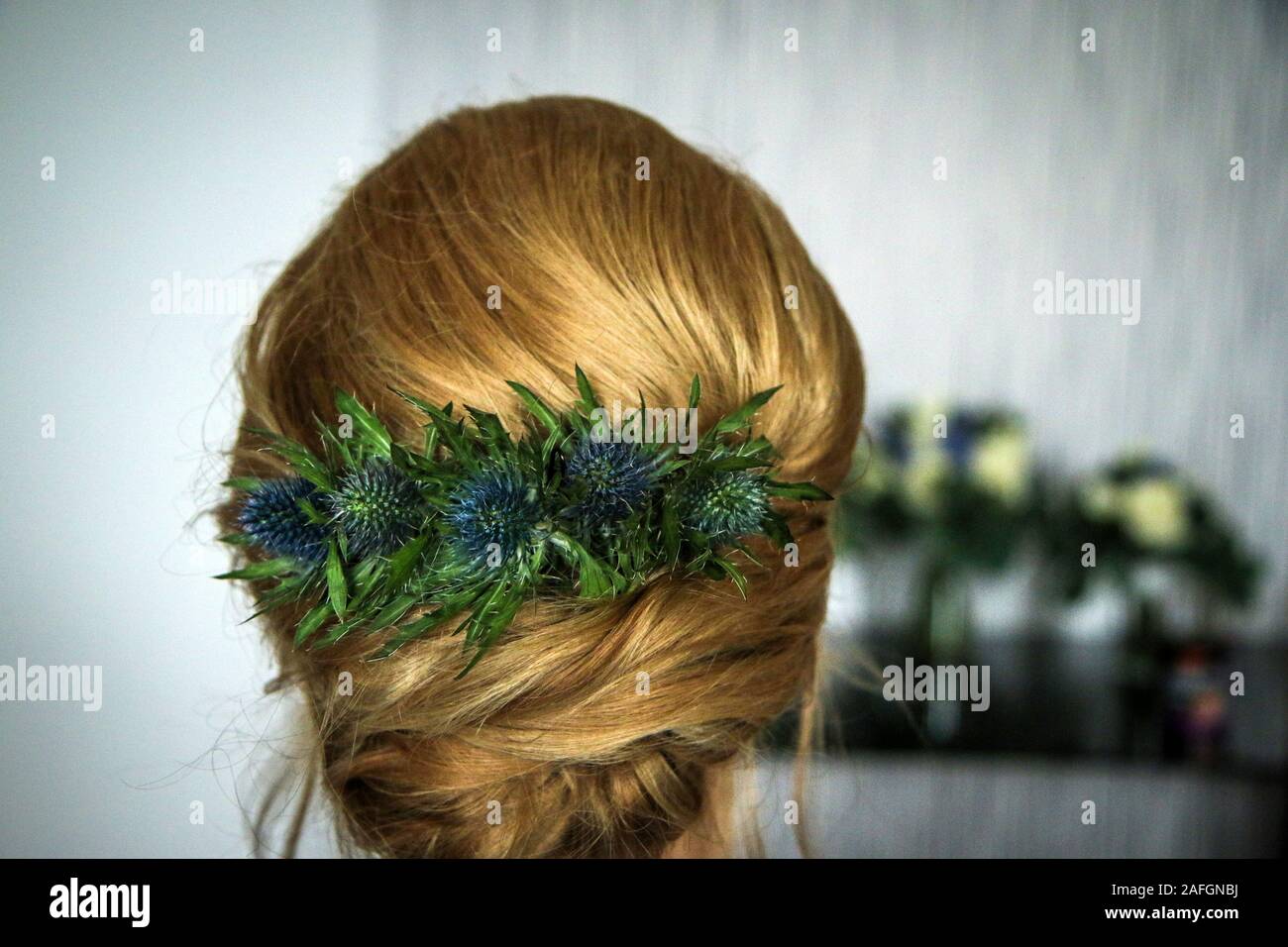 A detail of the hair of a bride. She has a decorative styling with some ...