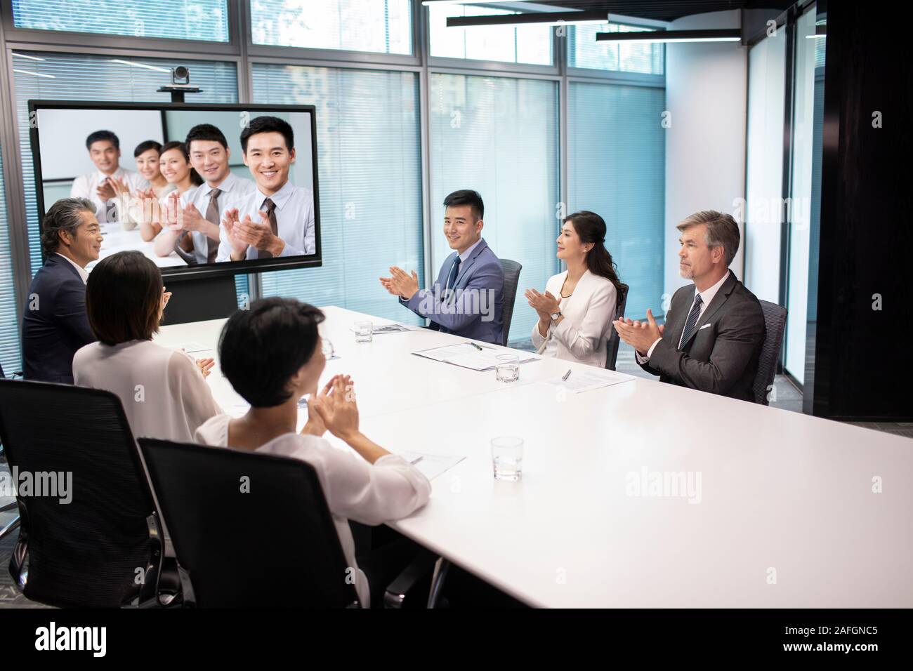 Business people clapping hands in conference room Stock Photo - Alamy