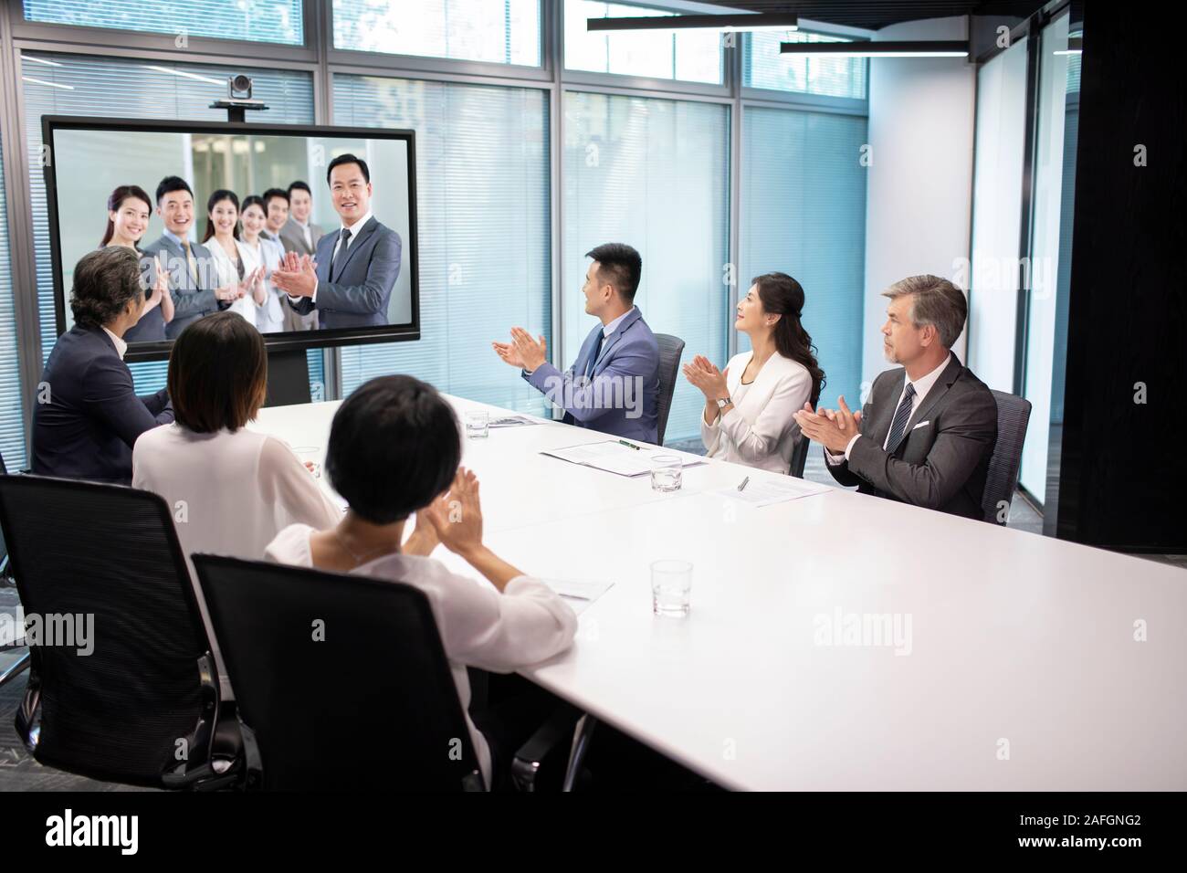 Business people clapping hands in conference room Stock Photo - Alamy