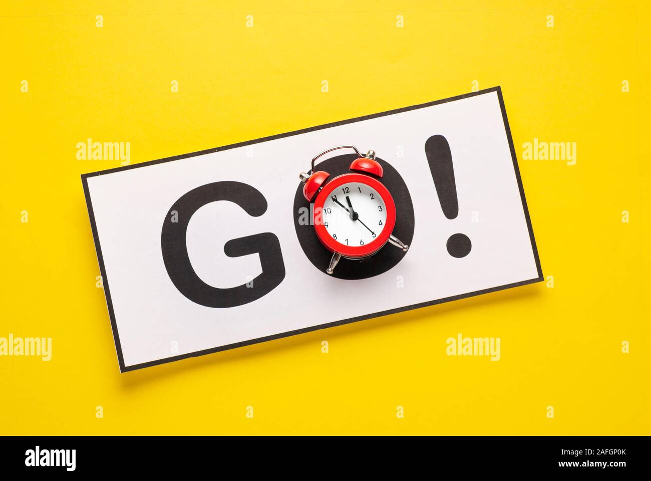 Go sign with alarm clock as O and copy space Stock Photo - Alamy