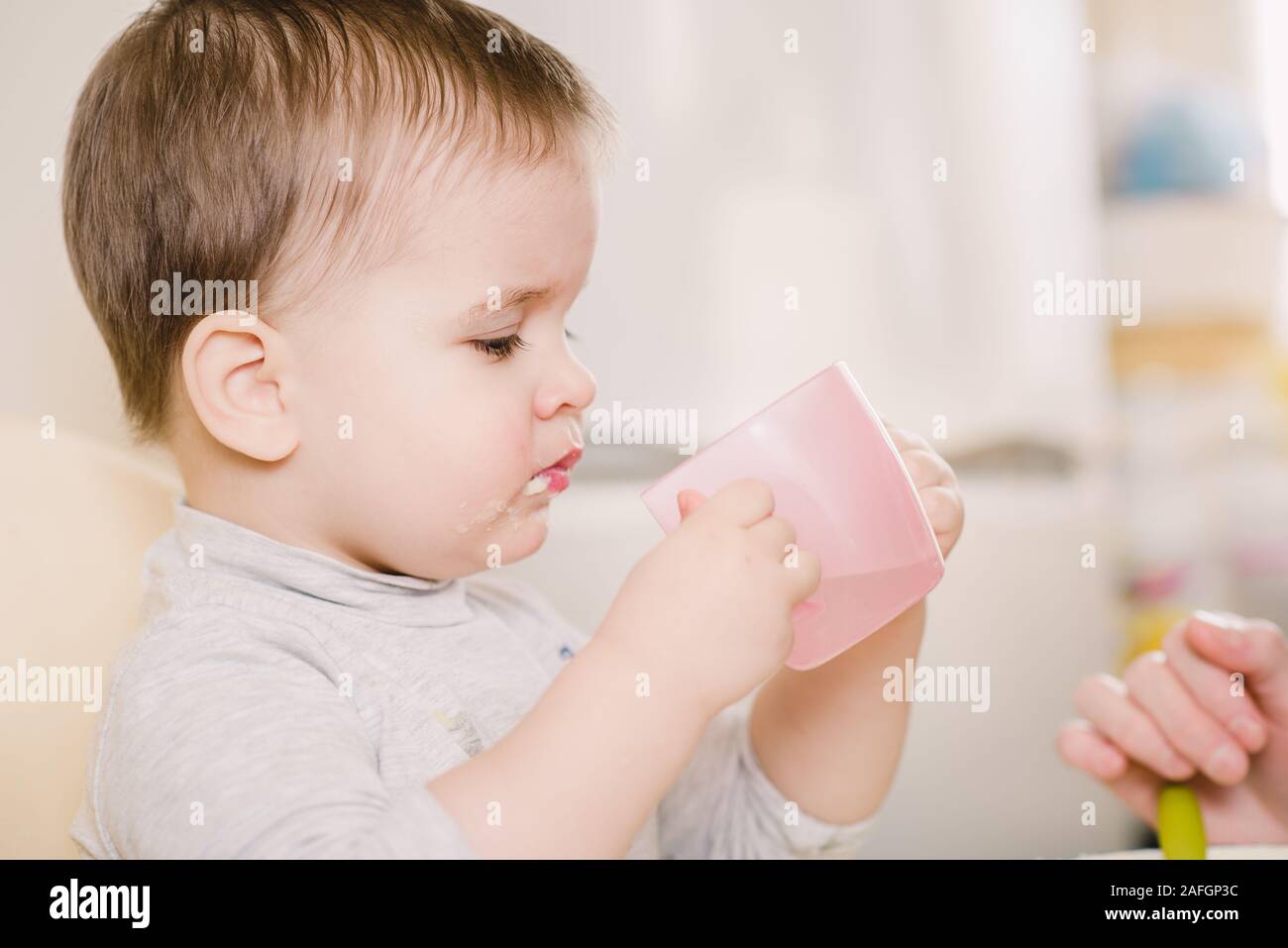 the child in the kitchen drinks water Stock Photo - Alamy