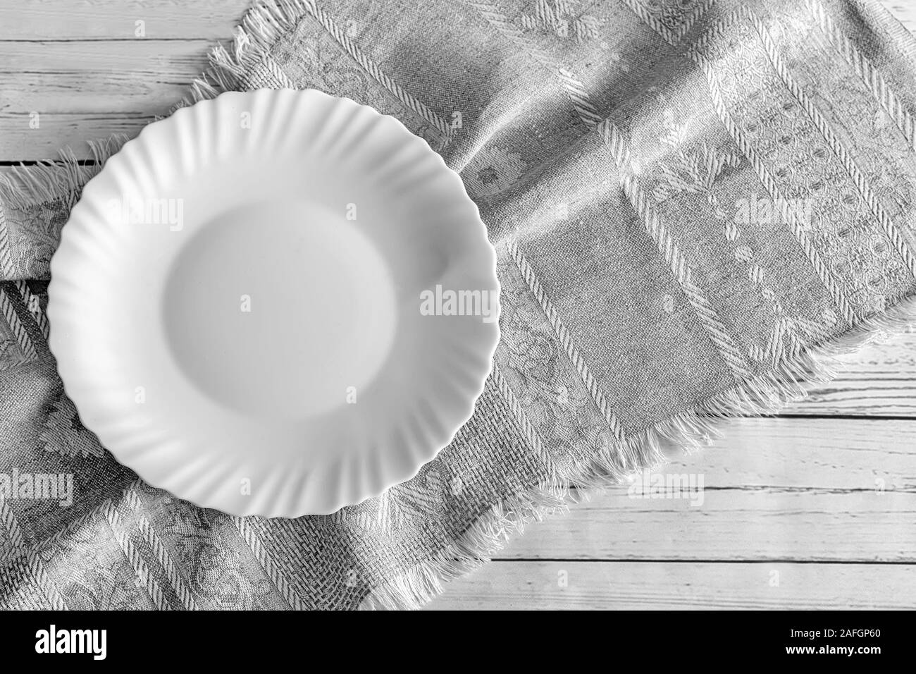 A white empty plate on a linen napkin Stock Photo - Alamy