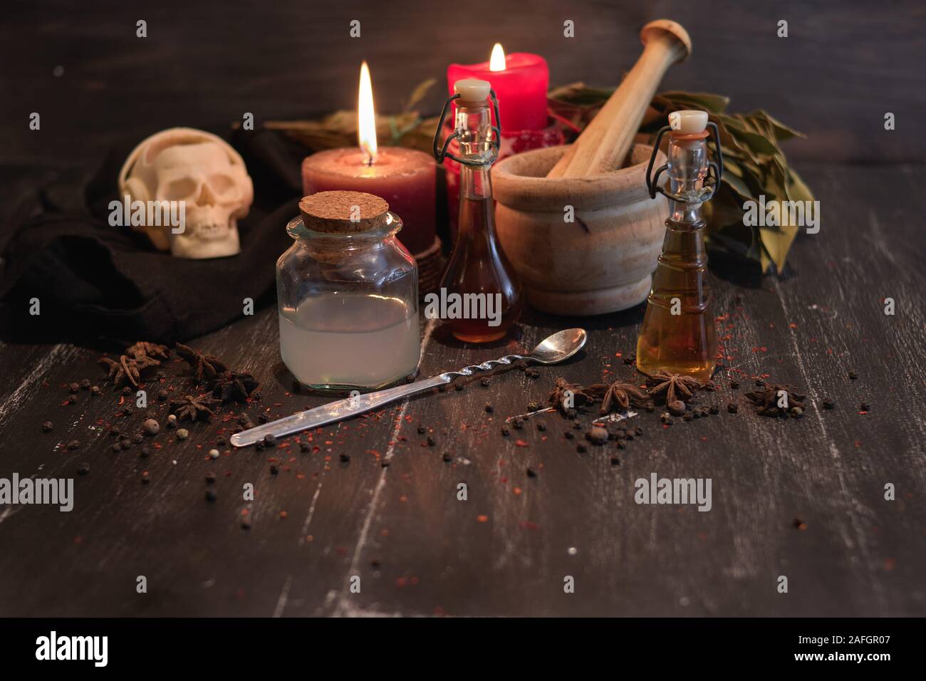 Potion of natural herbs for black magic, with mortar, skulls and ...