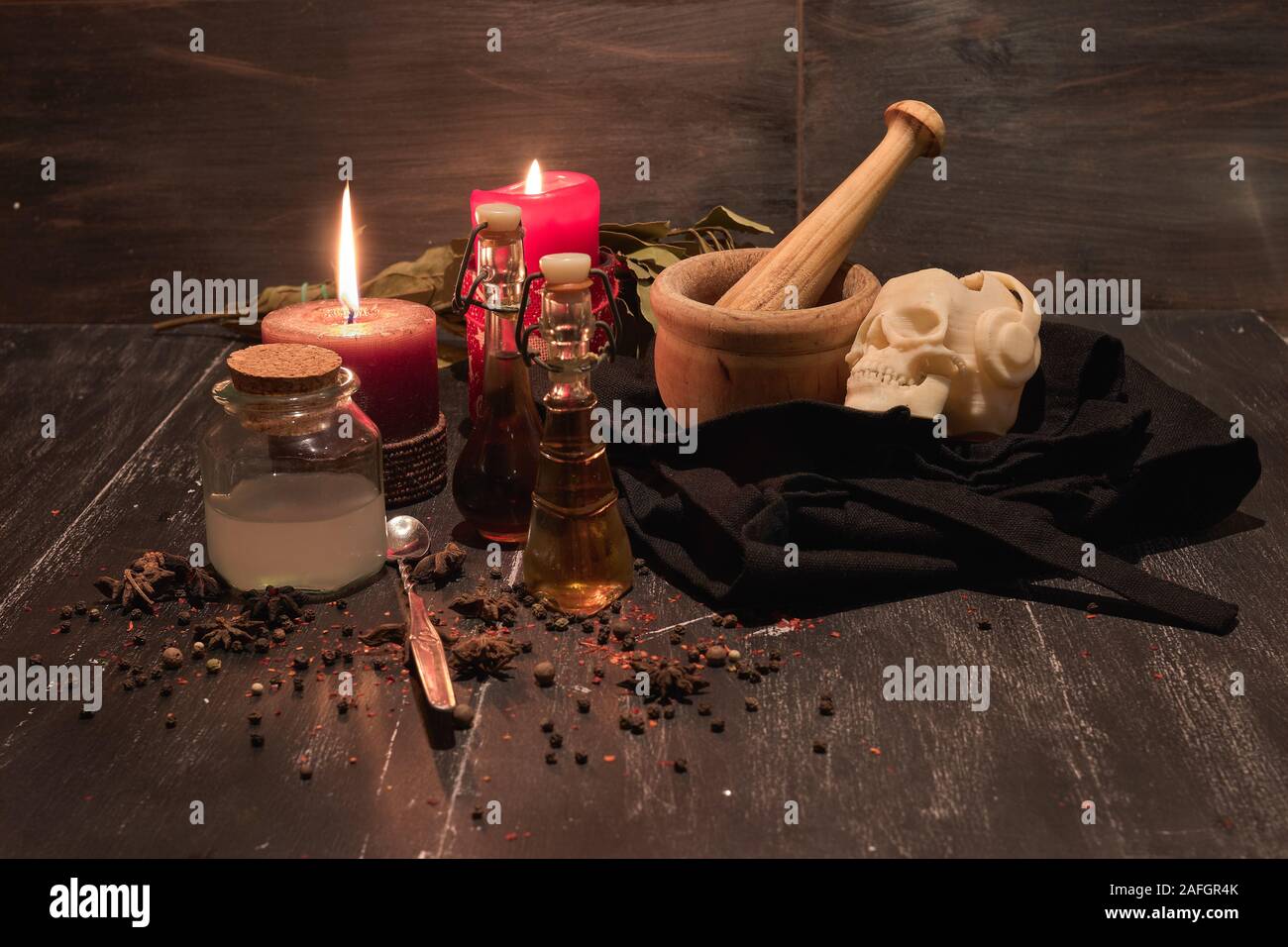 Potion of natural herbs for black magic, with mortar, skulls and ...