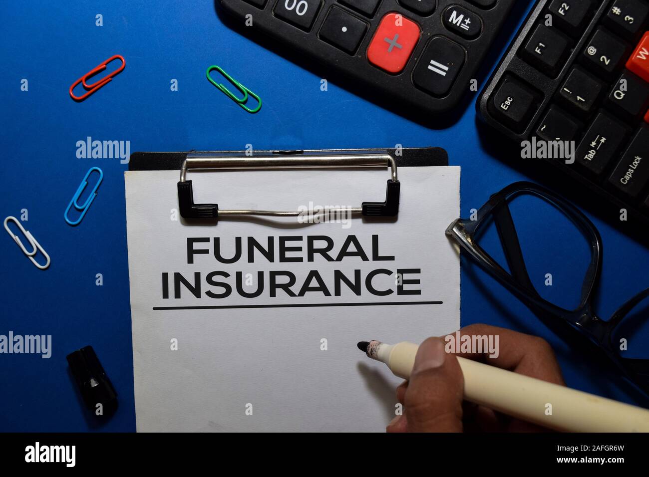 Funeral Insurance write on document isolated blue background Stock ...