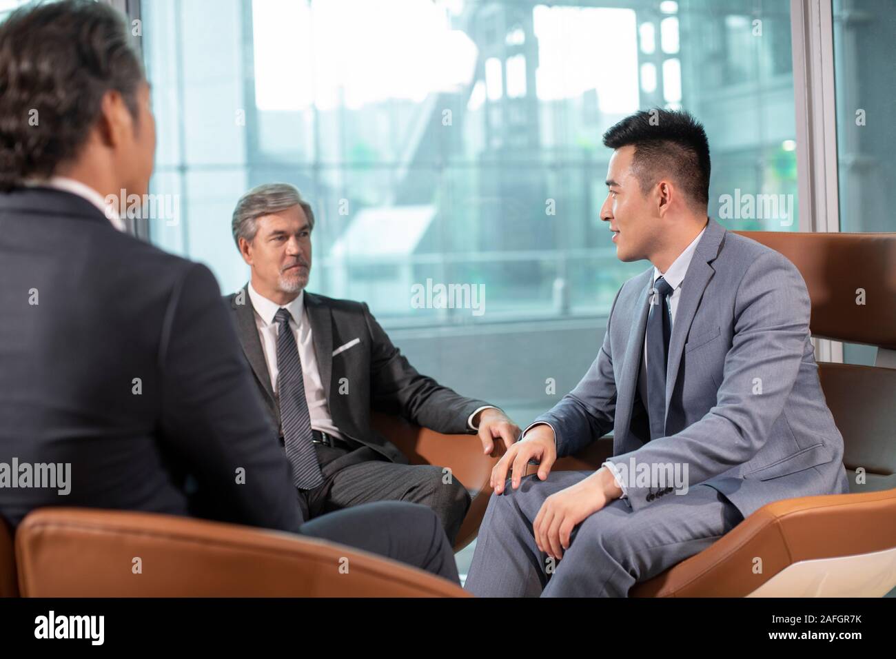 Businessmen talking in office Stock Photo - Alamy