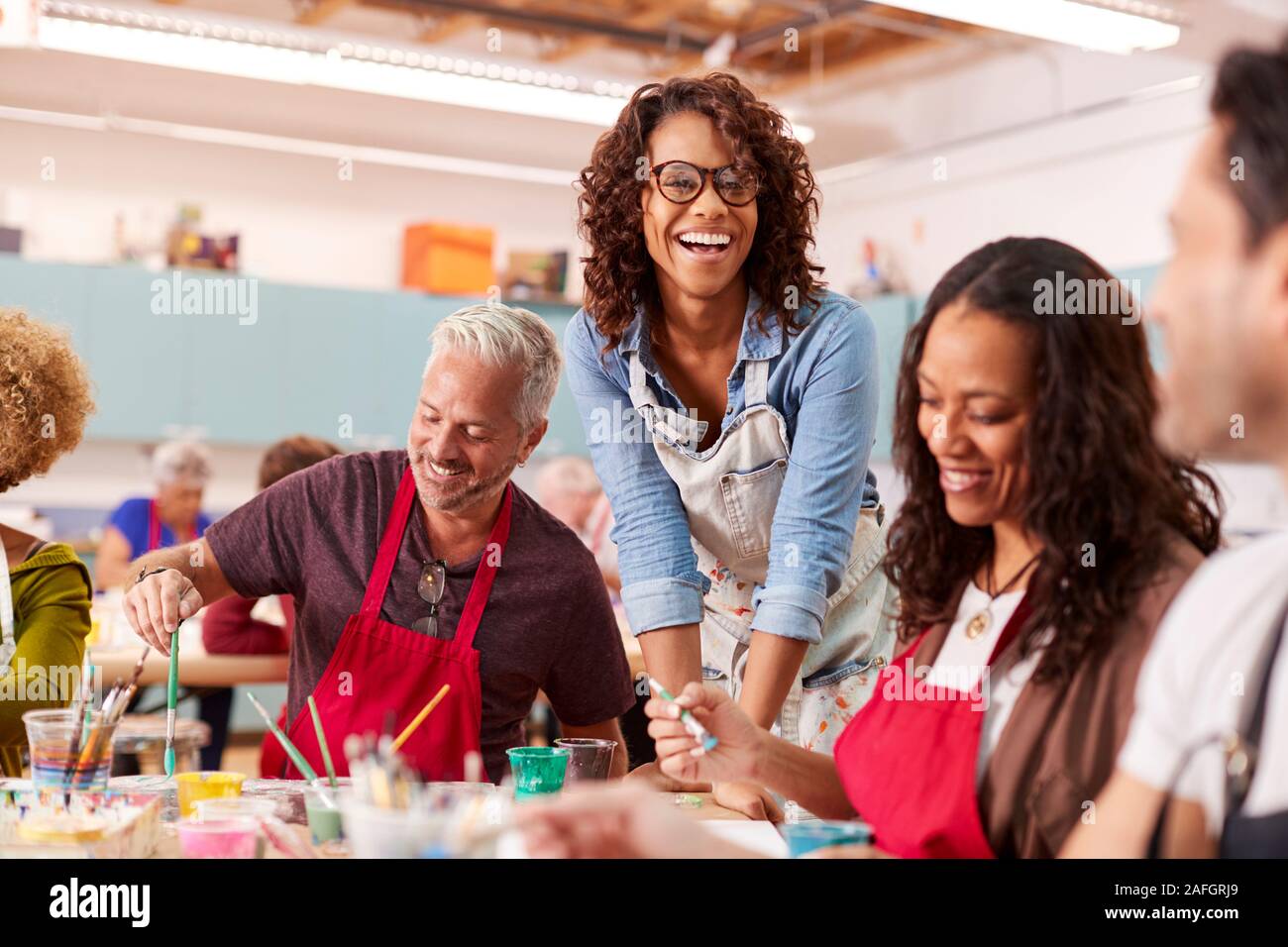 Group Of Mature Adults Attending Art Class In Community Centre With ...