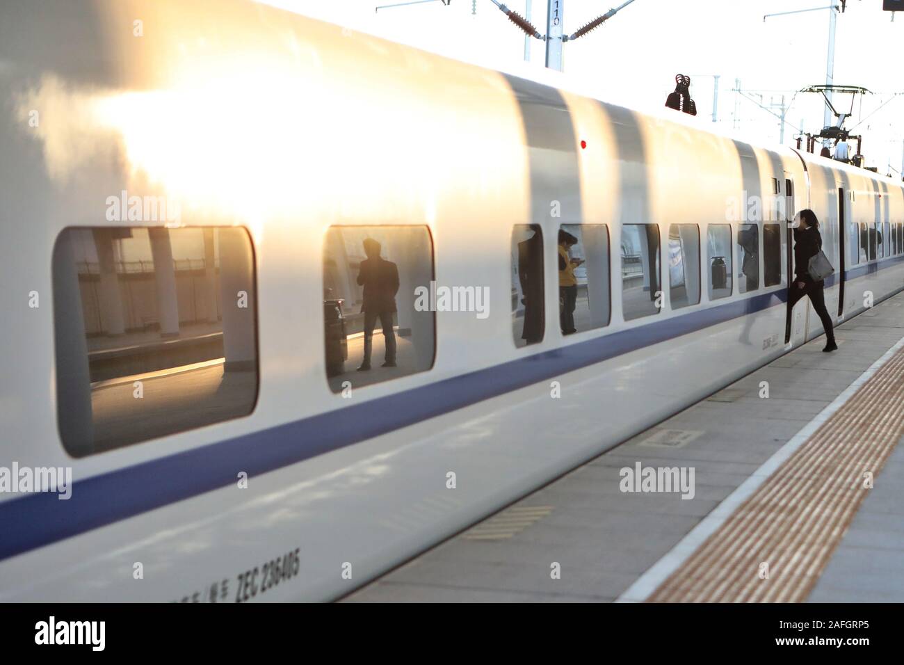Guiyang. 16th Dec, 2019. A passenger boards a bullet train of the ...