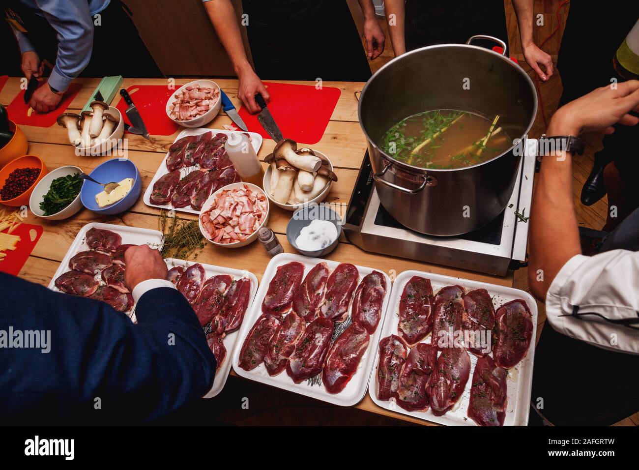 Process of cooking meat and soup at masterclass in restaurant. Hands of ...
