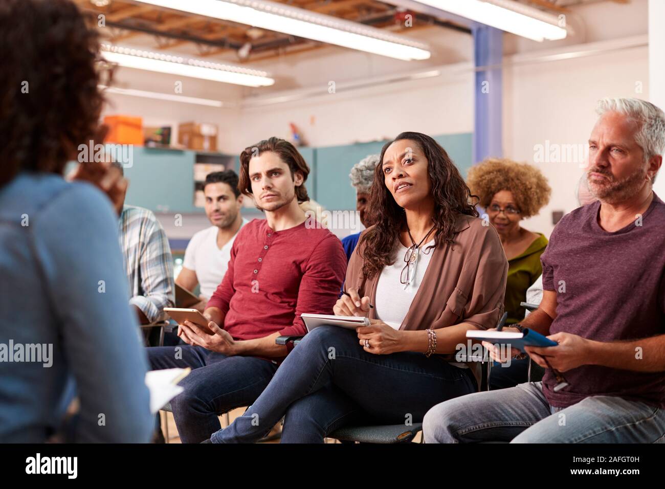 Group Making Notes Whilst Attending Neighborhood Meeting In Community ...