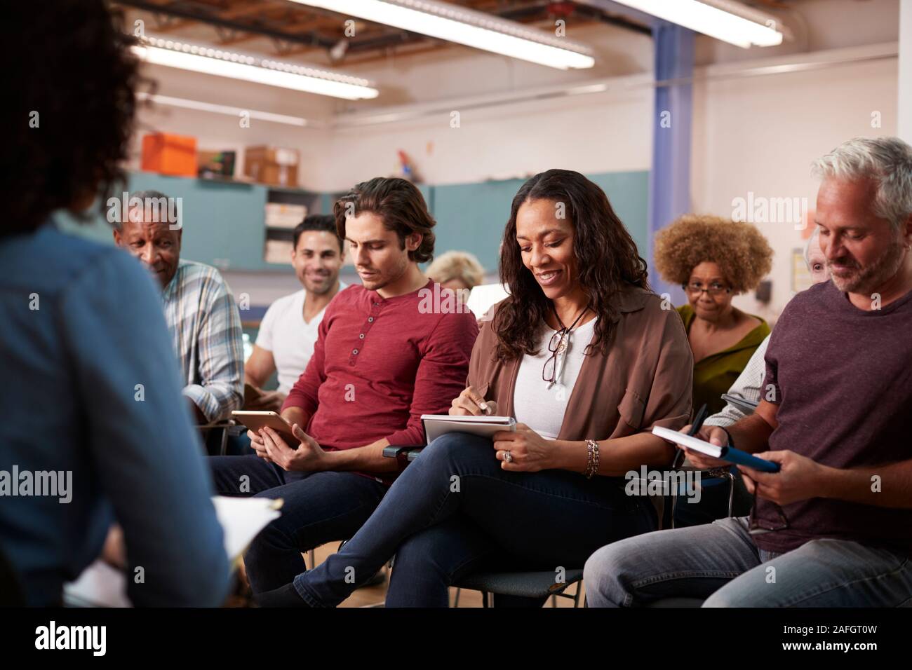 Group Making Notes Whilst Attending Neighborhood Meeting In Community ...