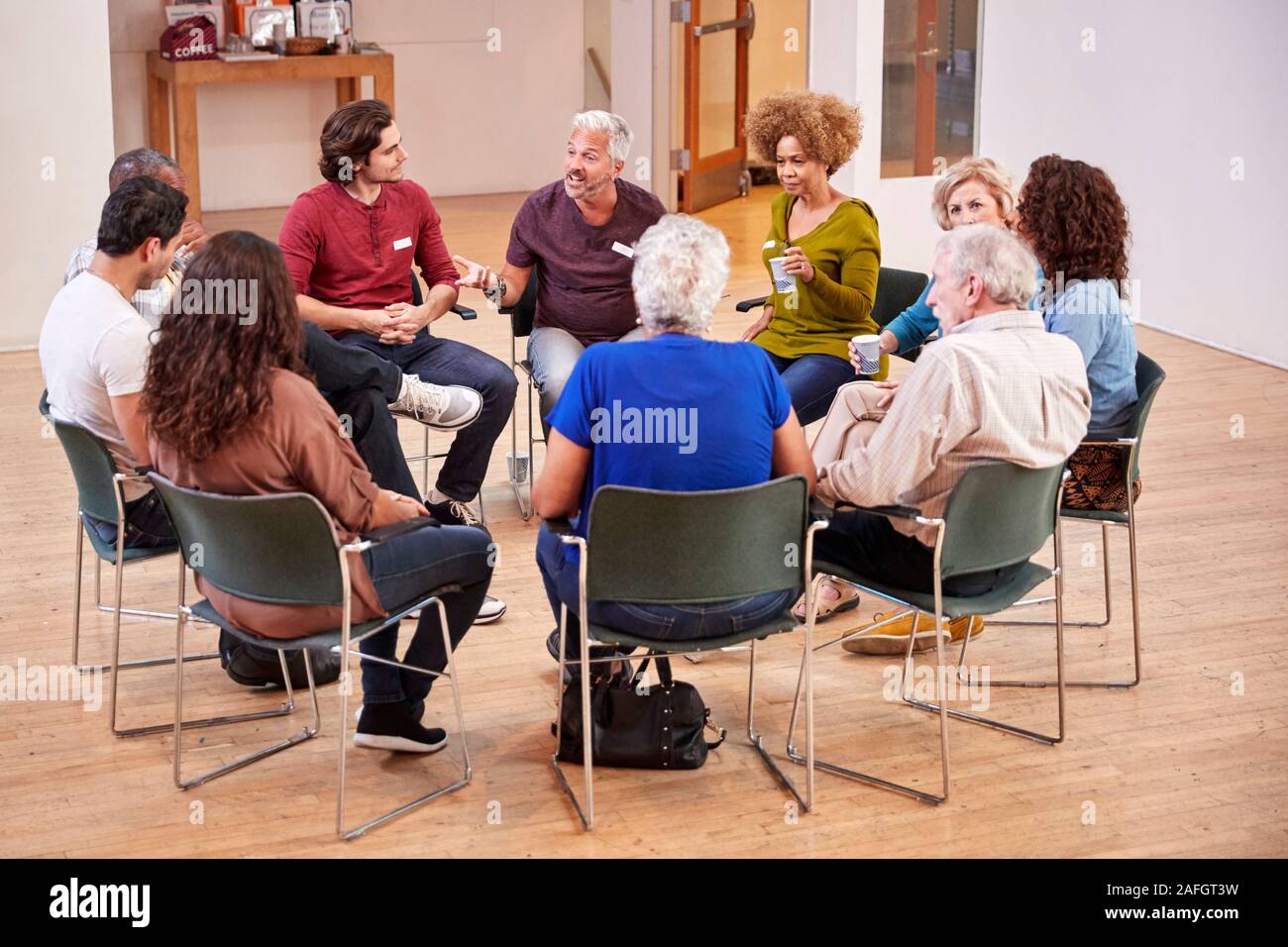 People Attending Self Help Therapy Group Meeting In Community Center ...