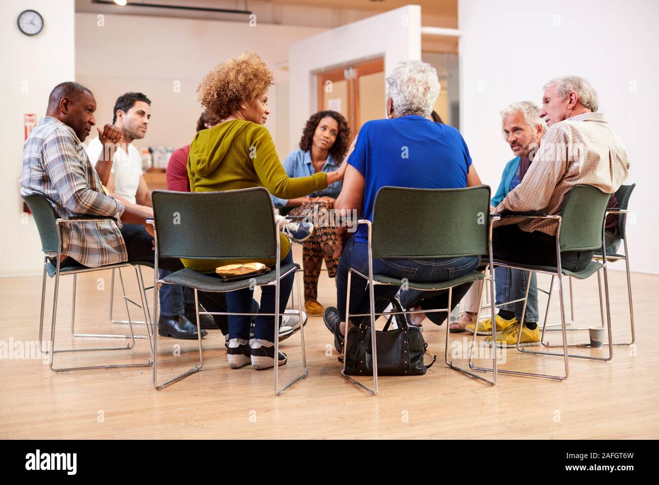 People Attending Self Help Therapy Group Meeting In Community Center ...