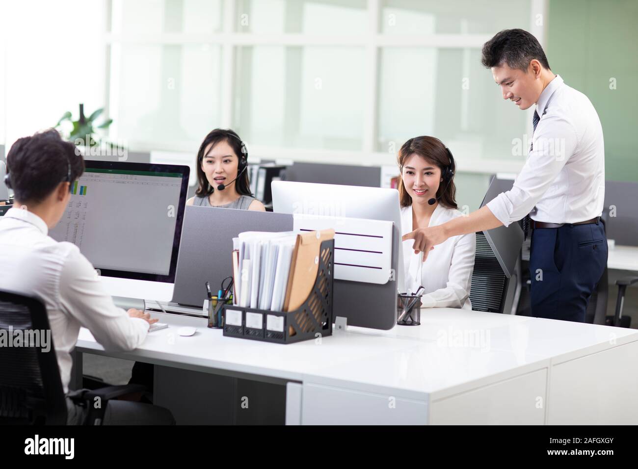 Call center agents working in office Stock Photo - Alamy
