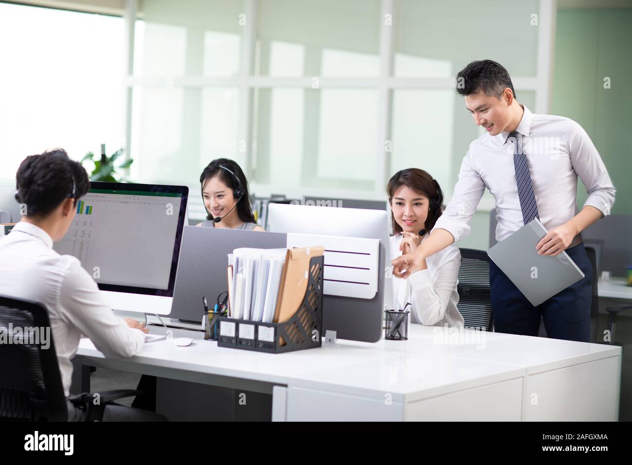 Call center agents working in office Stock Photo - Alamy