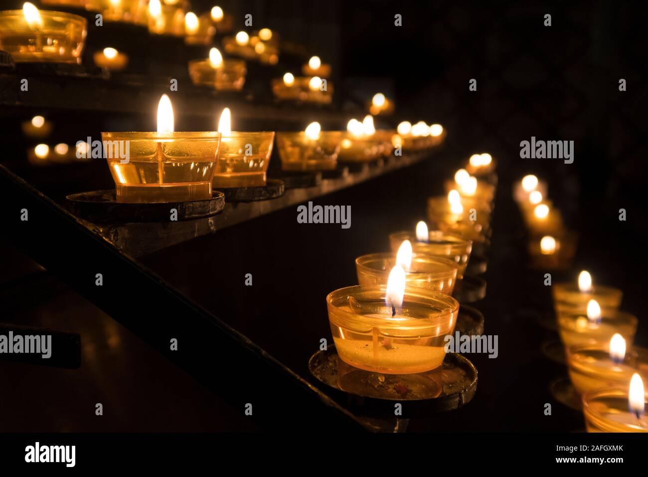 Row of candles in a church a symbol of religion and a memory of beloved ...