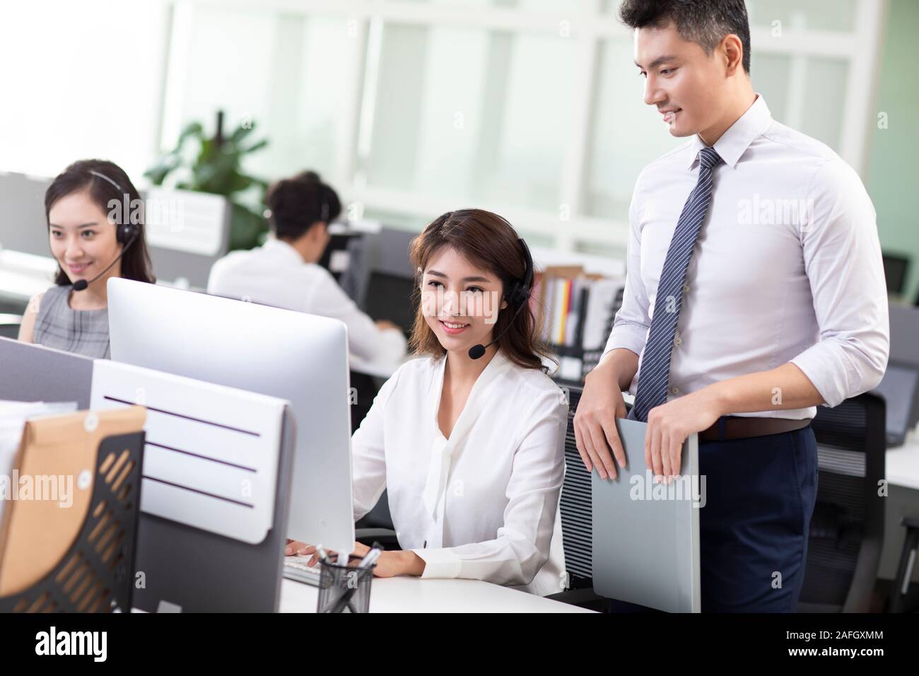 Call center agents working in office Stock Photo - Alamy